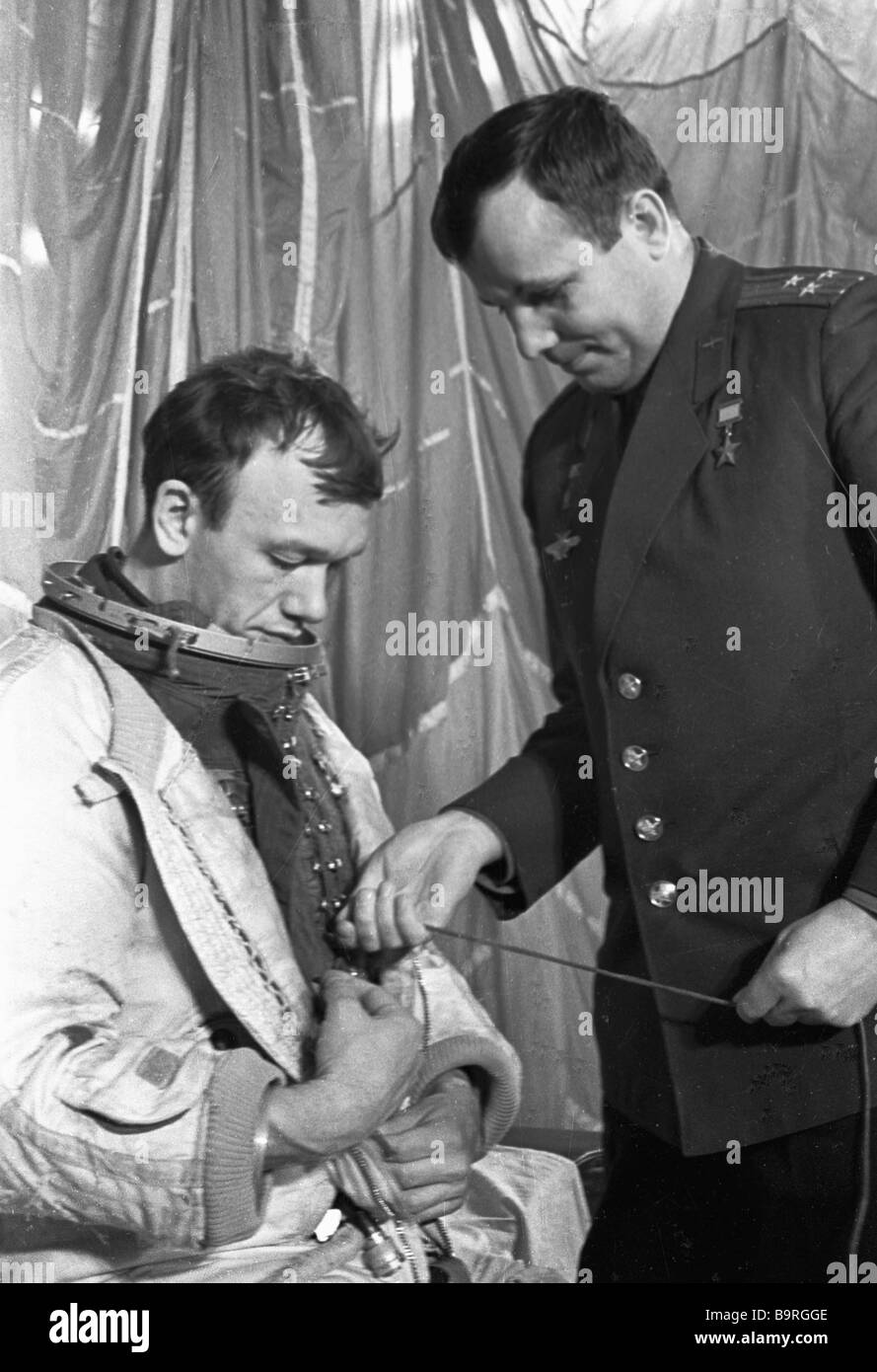 Pilot Cosmonaut of the U S S R Yury Gagarin right examines space suit ...