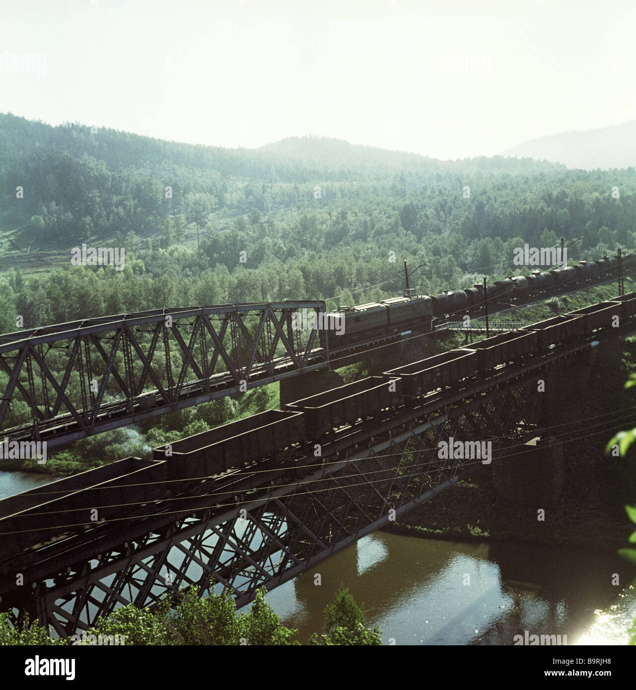 A train crossing a bridge along the Trans Siberian Railroad Line Stock ...