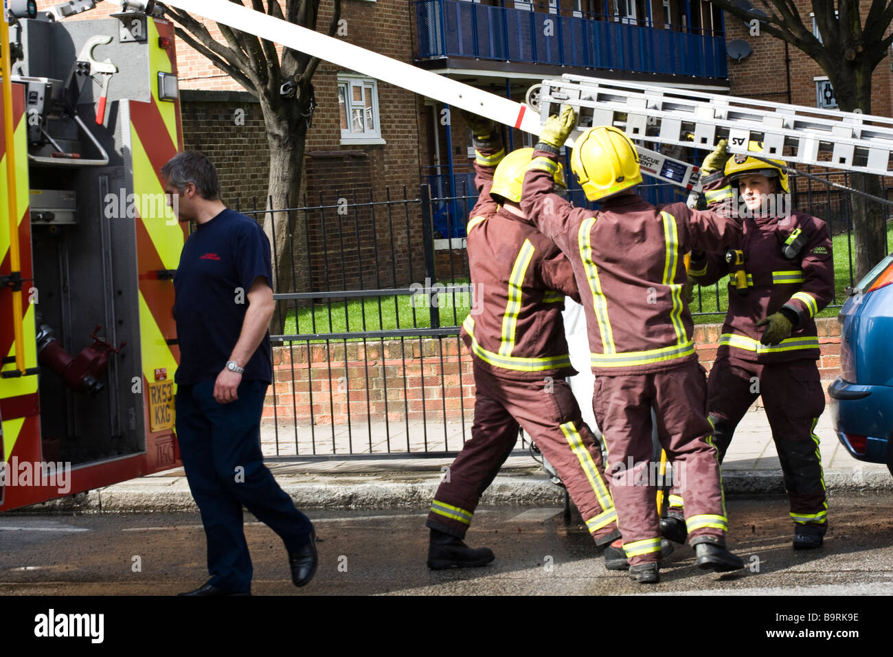 Ladder uk engine fire men fire woman Stock Photo - Alamy