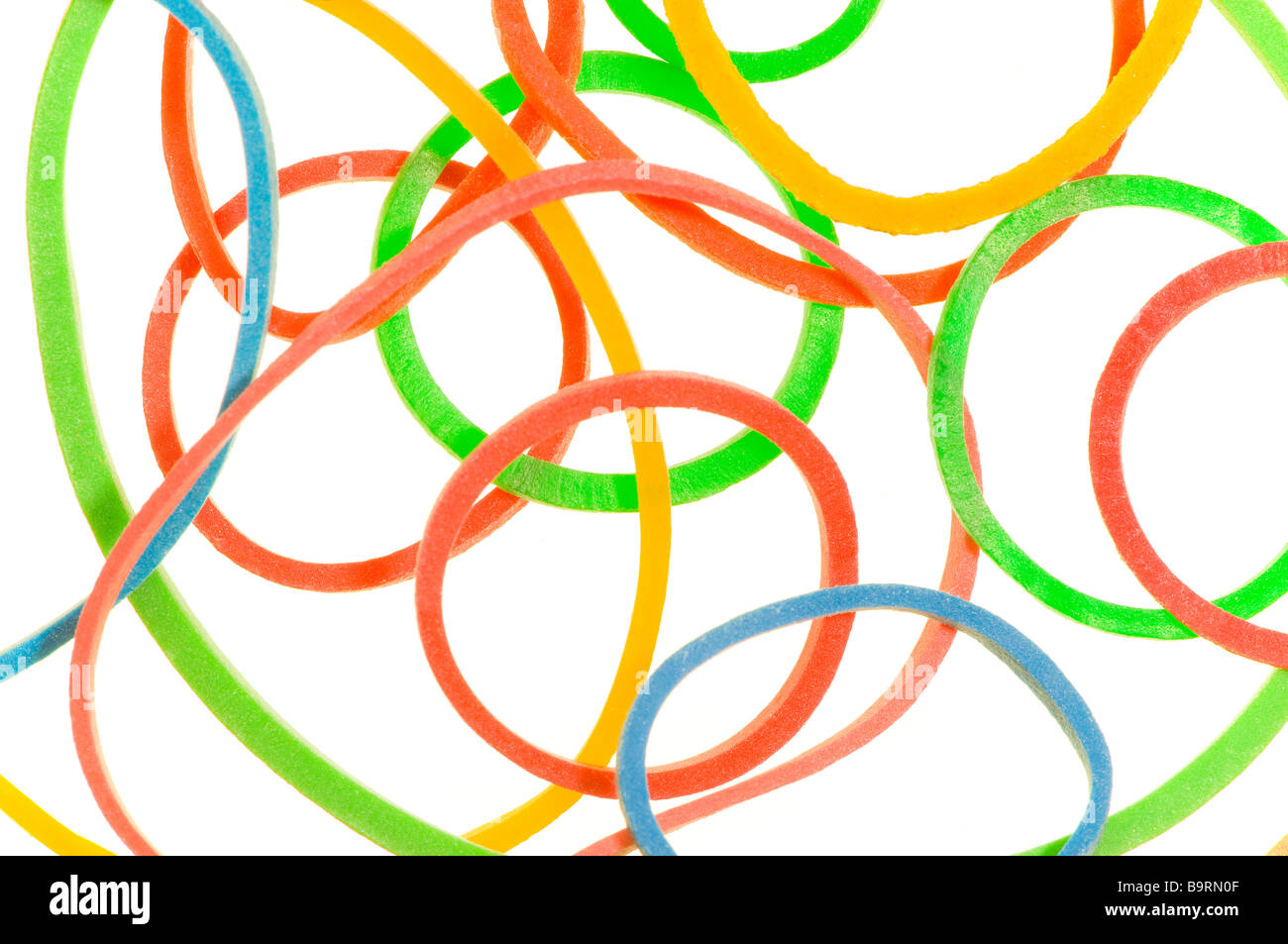 Colourful elastic bands on a white background Stock Photo - Alamy