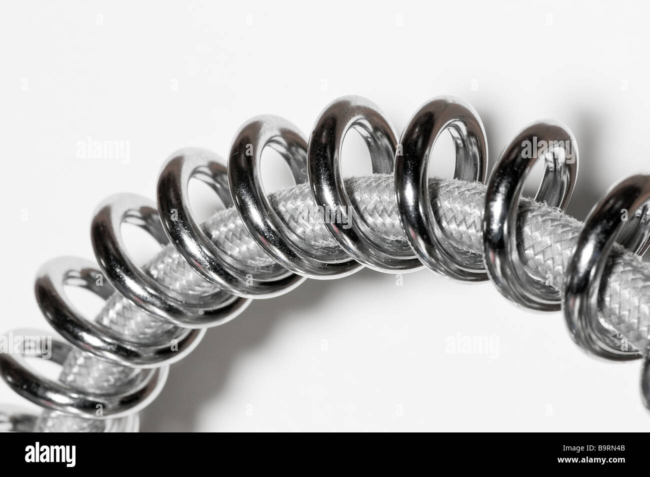 Spiral steel spring and hose, part of a modern kitchen tap Stock Photo ...