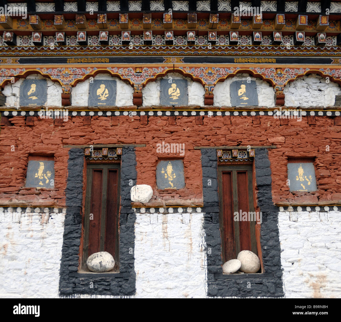 A building decorated in traditional Bhutanese fashion with painted beam ...