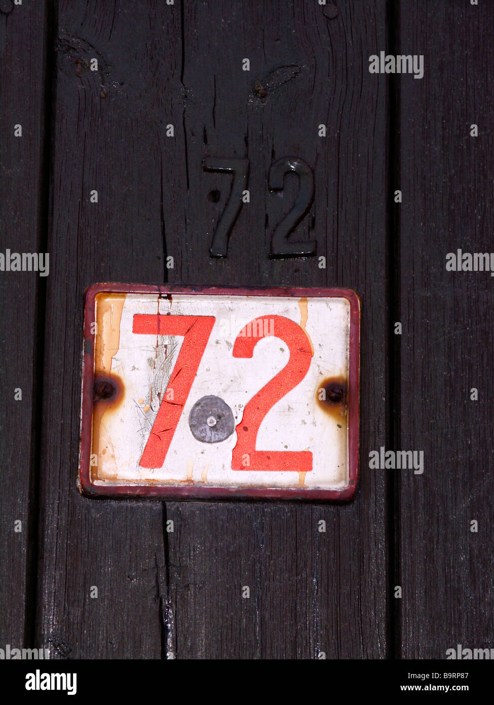 Numer 72 sign on old door Stock Photo - Alamy