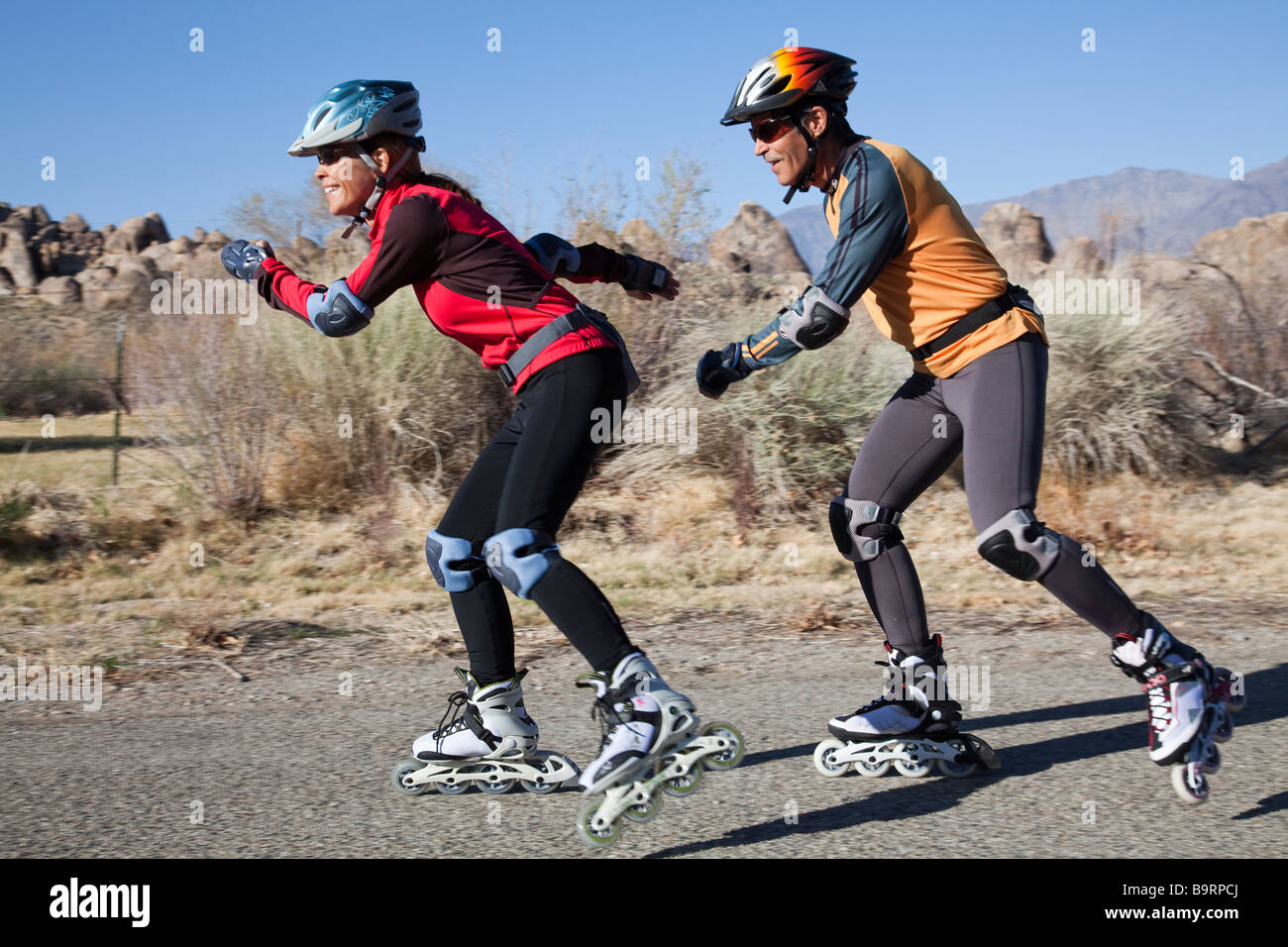 Couple roller blading Stock Photo - Alamy