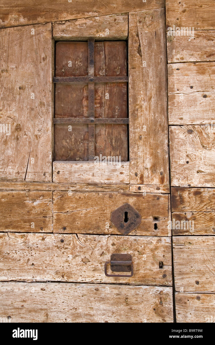 Brown wooden door with a barred window hi-res stock photography and ...