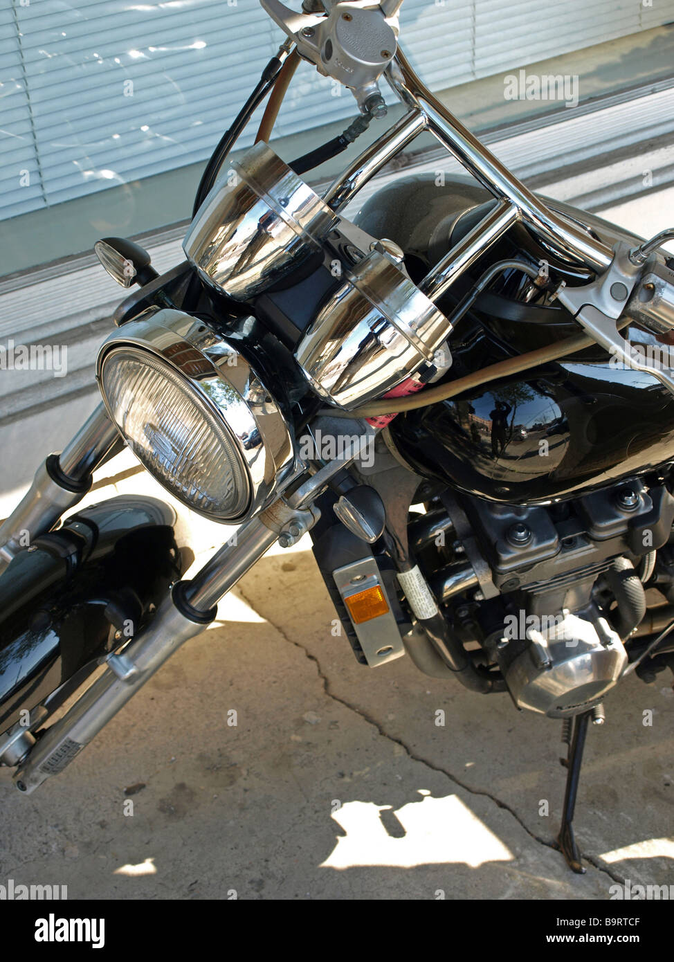 motorcycle scooter motorbike showing the engine, front light, part of ...