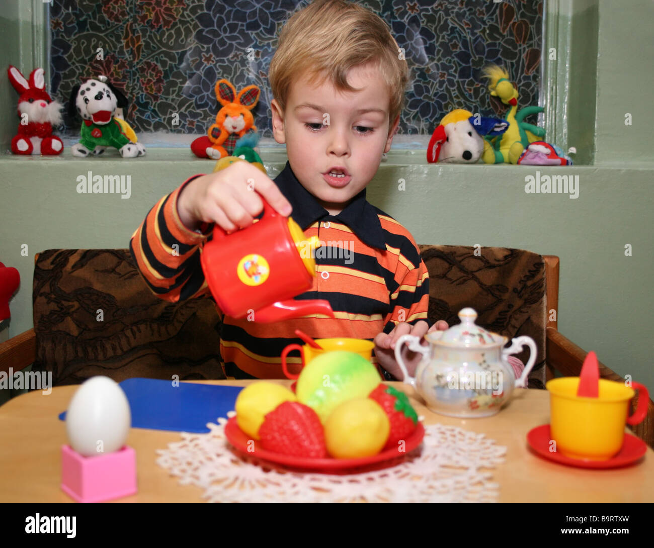 child play tea in kindergarten Stock Photo - Alamy