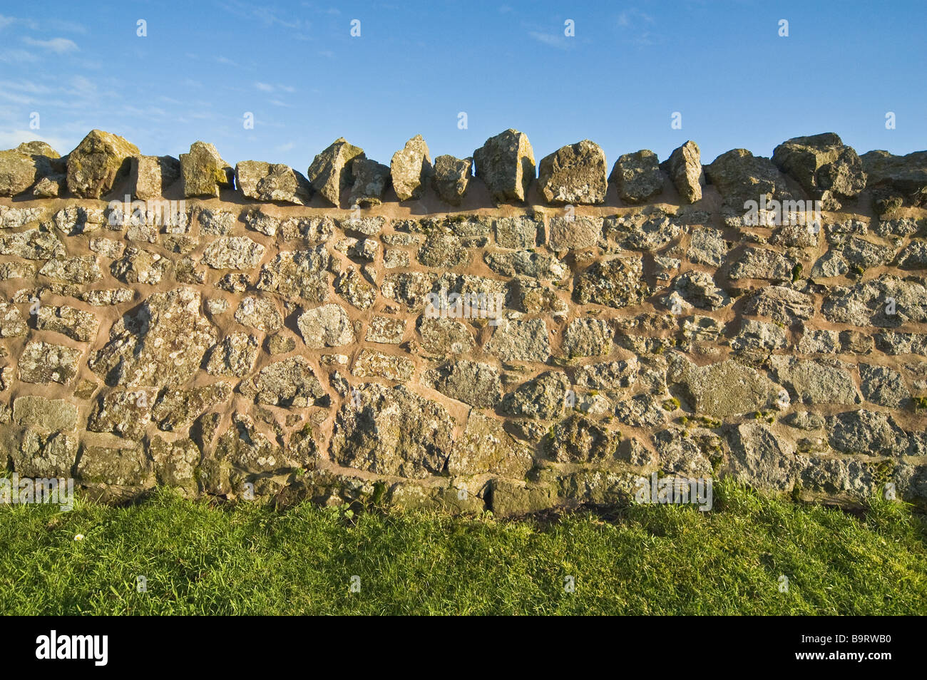 A well-built stone wall marking the boundary of a field Stock Photo - Alamy