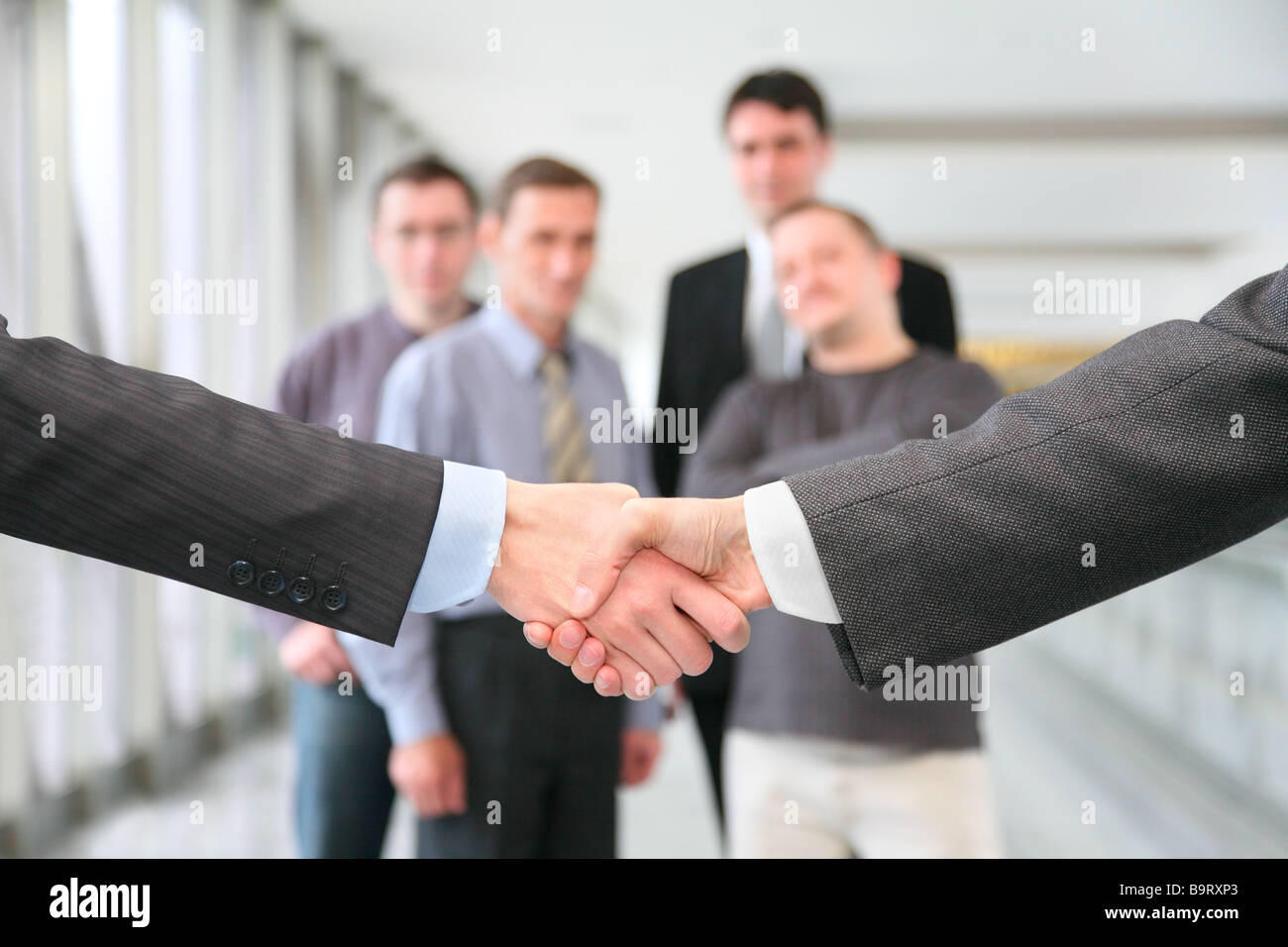 shaking hands with wrists and business team 2 Stock Photo - Alamy