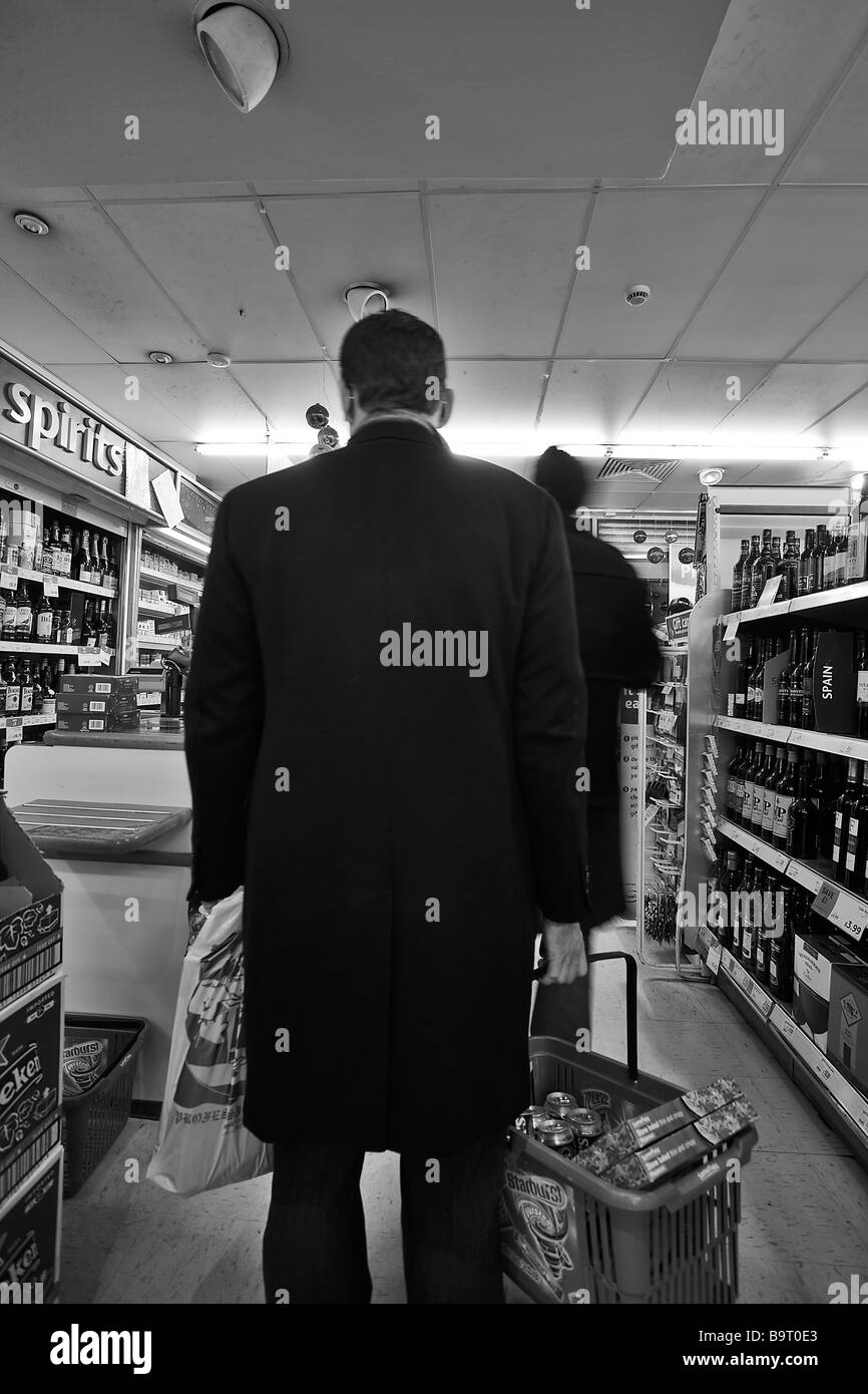 Shopping for one: a man waiting in line late at night in a Soho, London ...