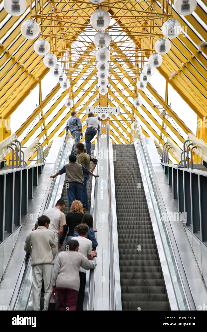 People on the escalator of pedestrian bridge Stock Photo - Alamy