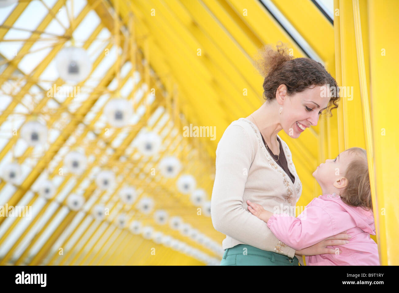mother with baby on yellow bridge Stock Photo - Alamy