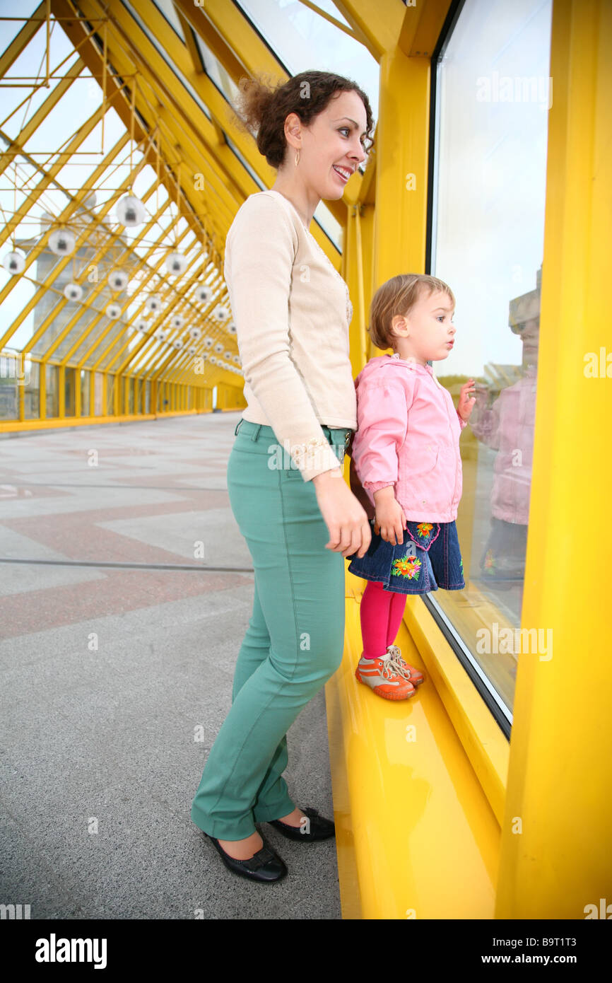 young woman with baby on pedestrain bridge Stock Photo - Alamy