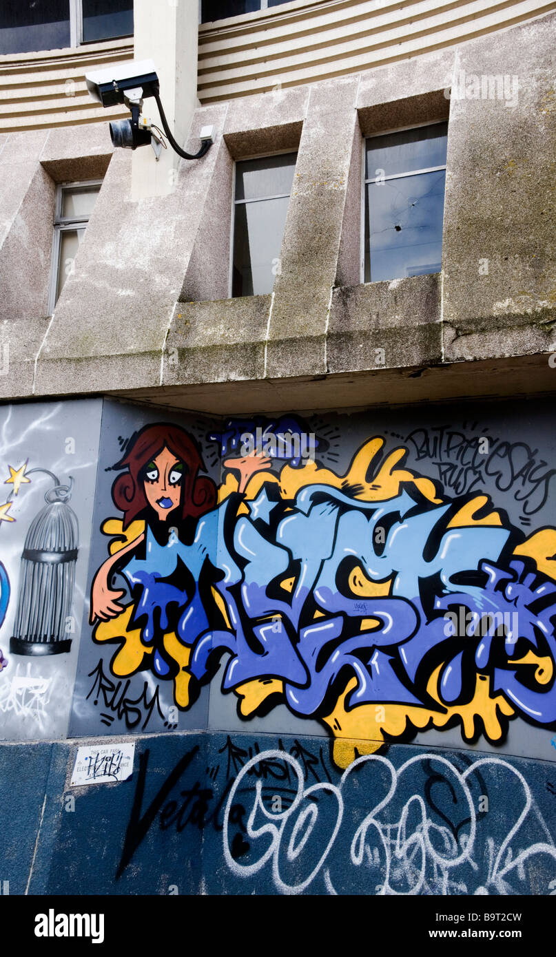 Graffiti on wall within sight of CCTV camera Stock Photo - Alamy