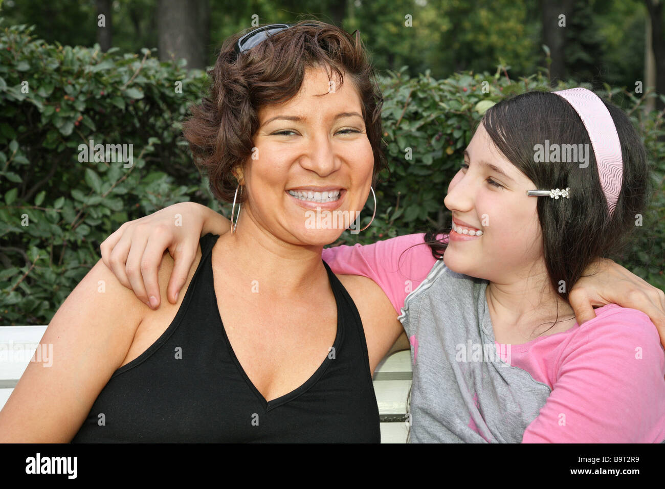 mother and daughter sit on the bench Stock Photo - Alamy