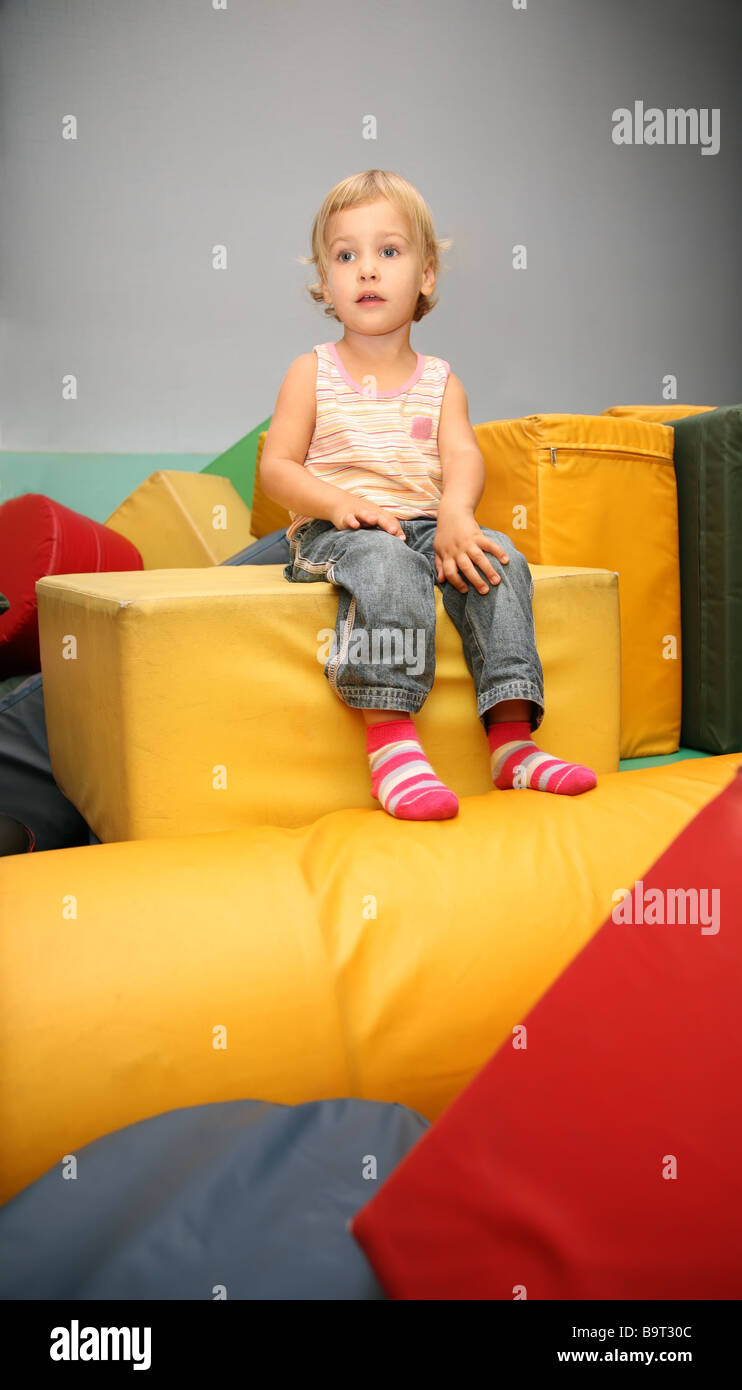 girl sit on yellow cube Stock Photo - Alamy