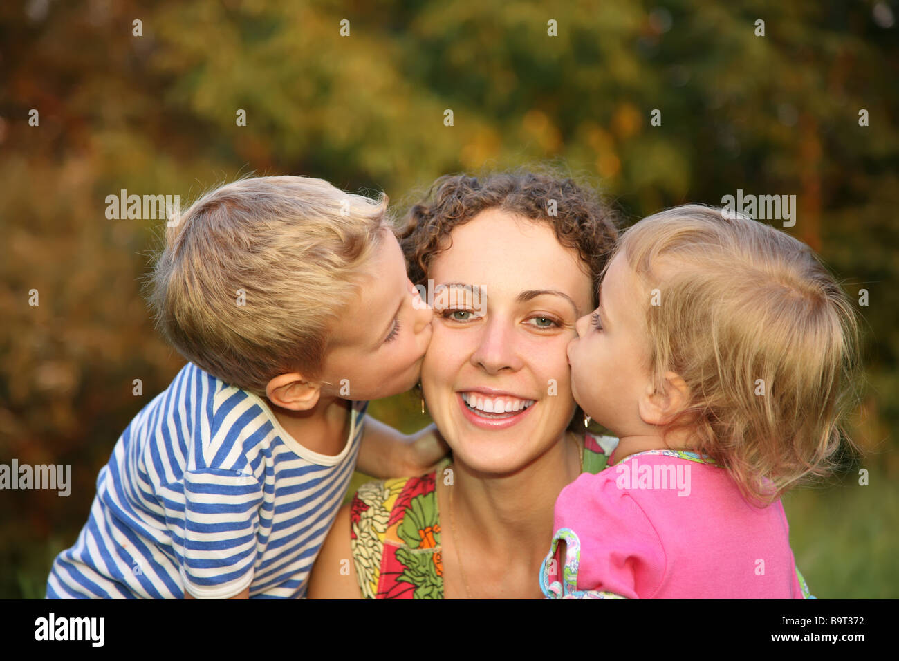 children kiss the mother Stock Photo - Alamy