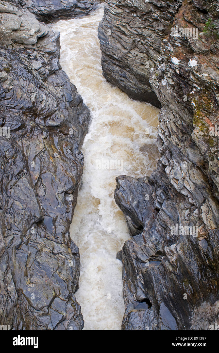 Surging waters pass through the narrow rocky gorge of the Linn of Dee ...