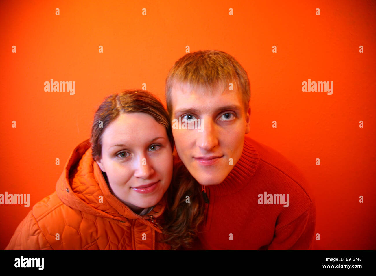 Pair together on an orange background Stock Photo - Alamy