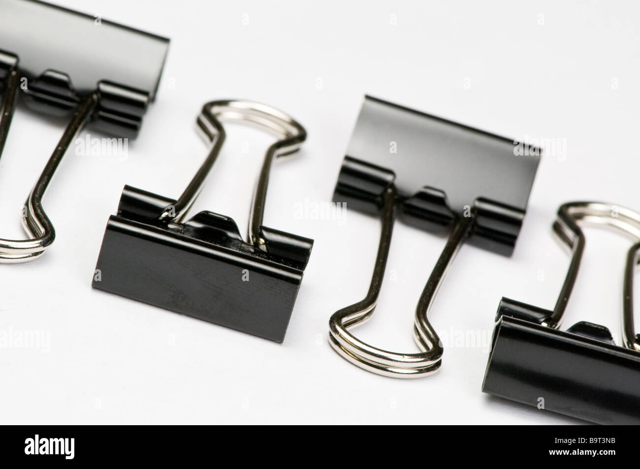 A line of fold-back (bulldog) clips against a white background Stock ...