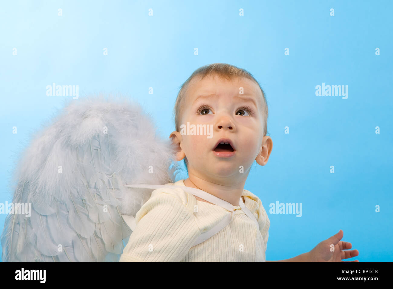 amazed boy dressed as Cupid on blue background Stock Photo - Alamy