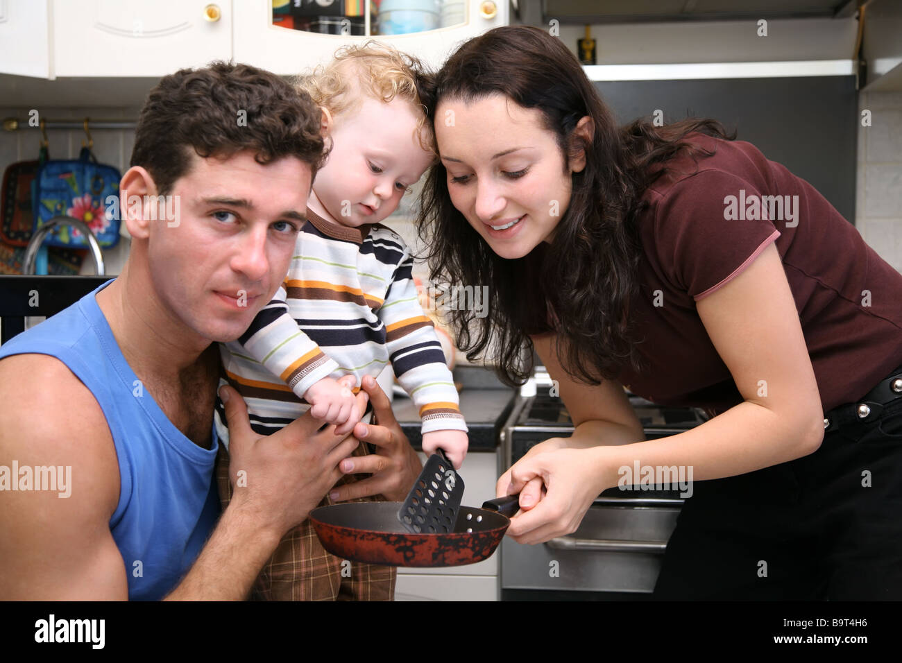 father, mother, child and frying pan on the kitchen Stock Photo - Alamy