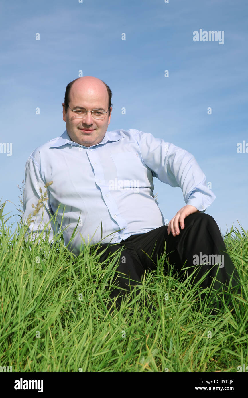 fat man sitting grass Stock Photo - Alamy
