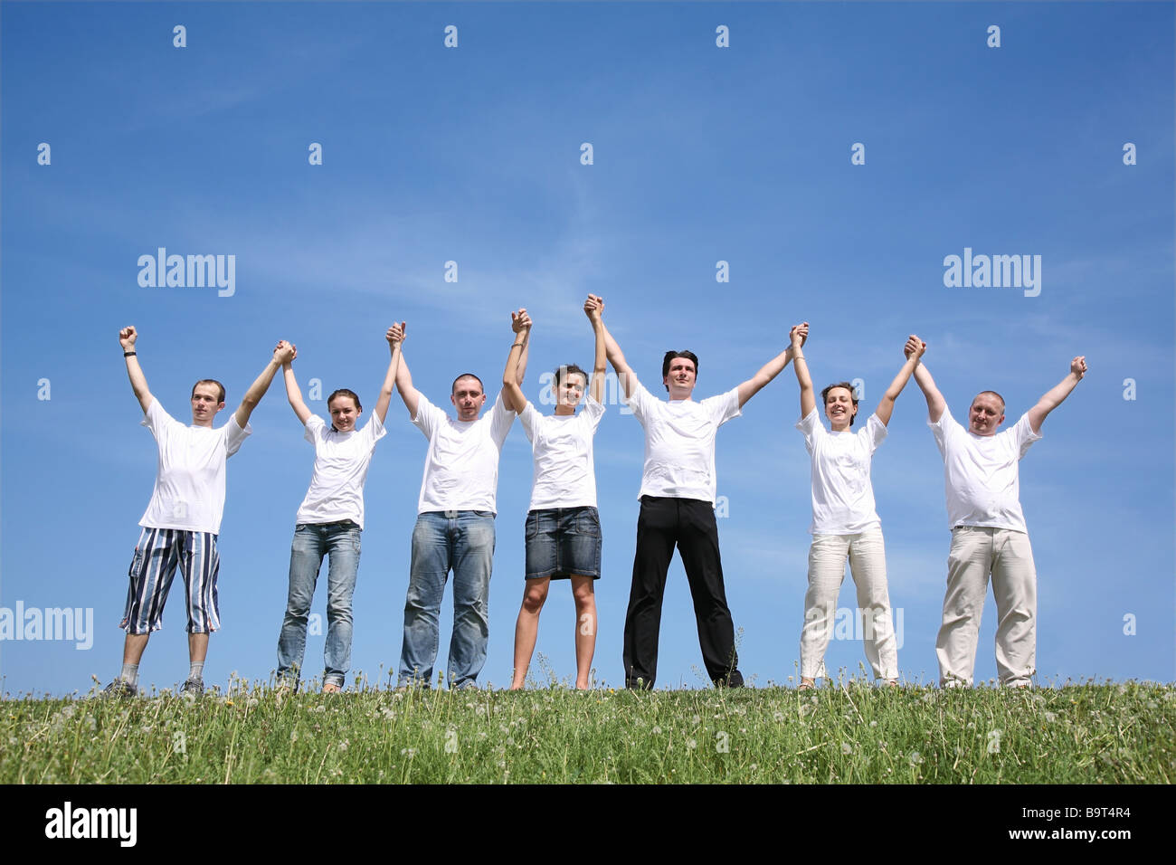 Seven friends in white shirts have waved hands Stock Photo - Alamy