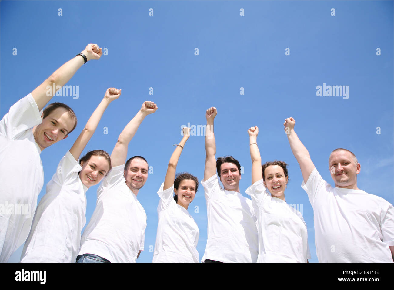 Group of friends in white T-shorts have waved upwards hands Stock Photo ...