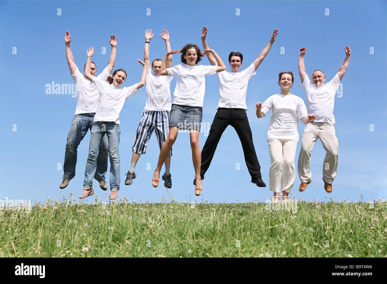 Seven friends in white T-shirts are in a jump Stock Photo - Alamy