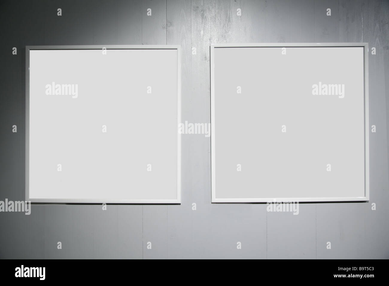 two frames on white wood wall Stock Photo - Alamy