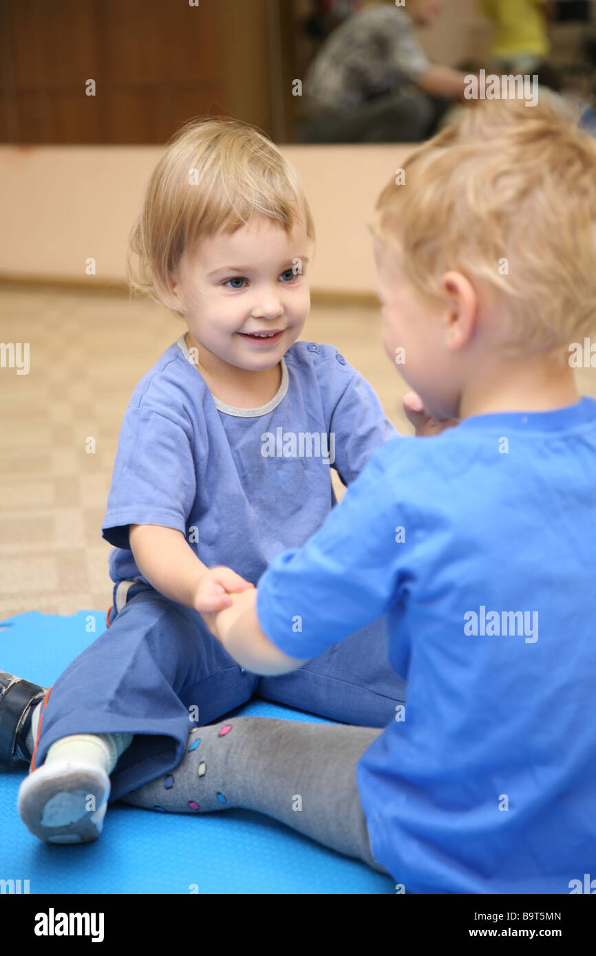 girl and boy sit and play Stock Photo - Alamy