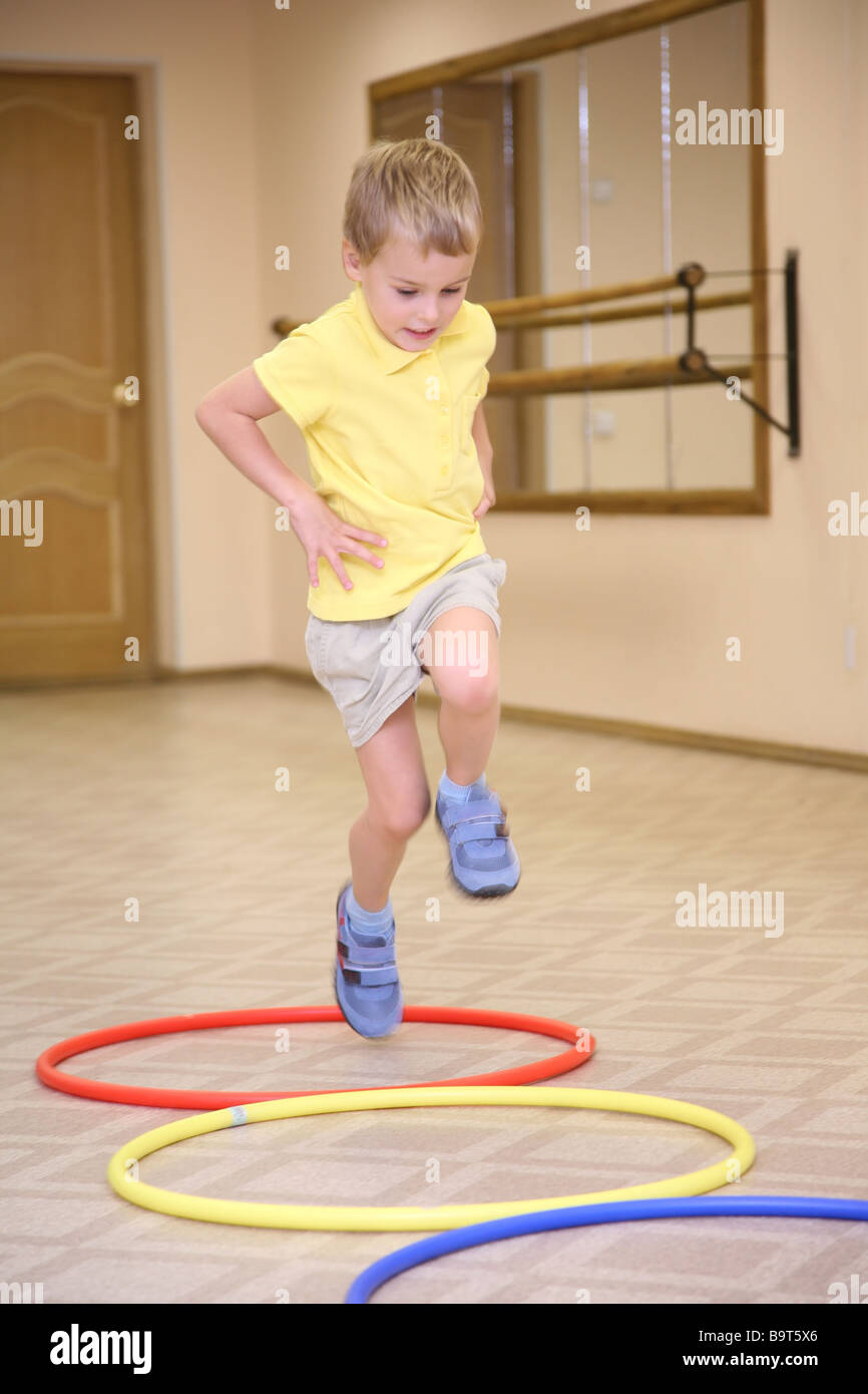 boy makes exercise with hoops Stock Photo - Alamy