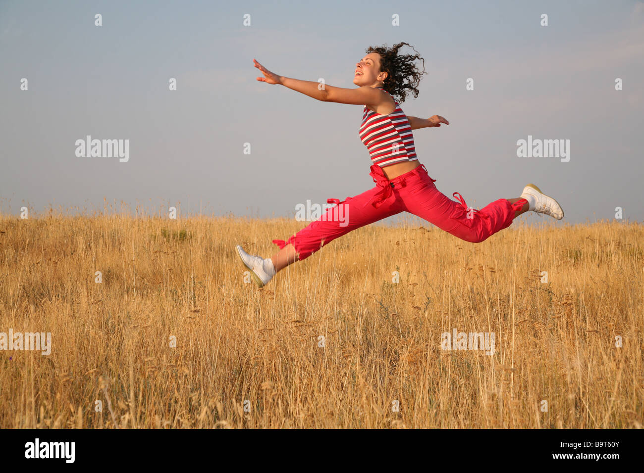 young woman jump on the meadow Stock Photo - Alamy