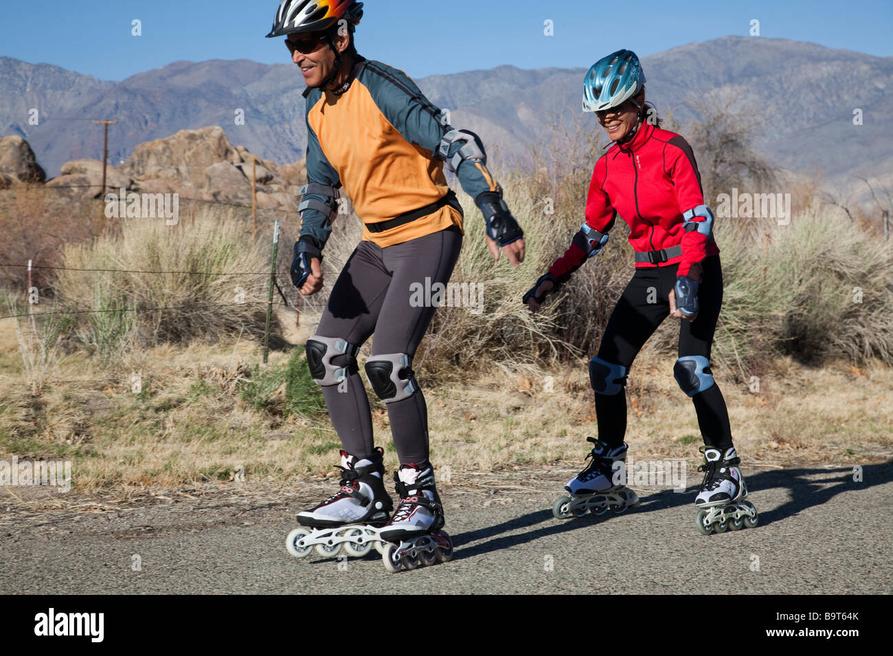 Couple roller blading Stock Photo - Alamy