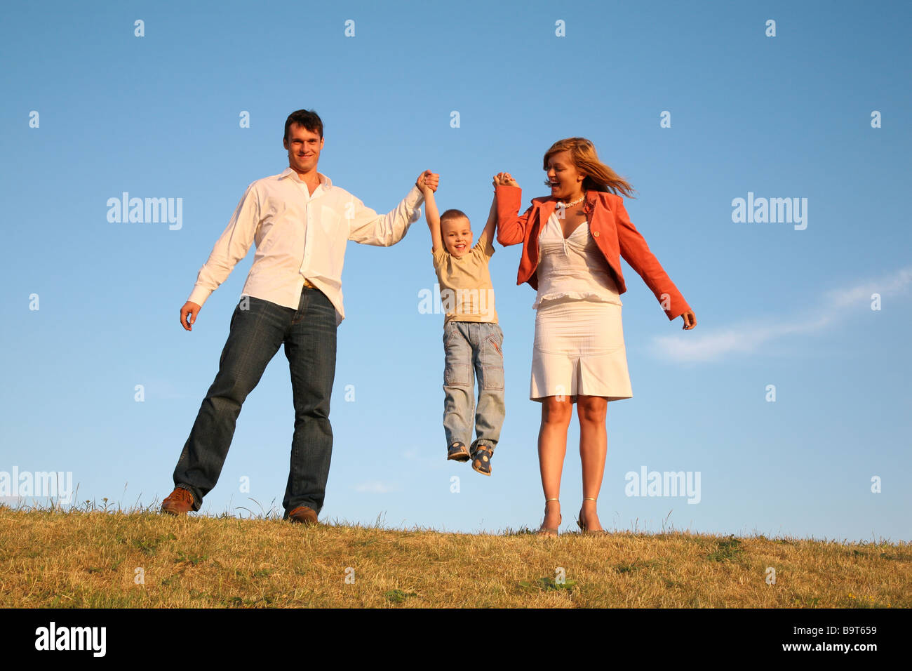 parents hold the child Stock Photo - Alamy