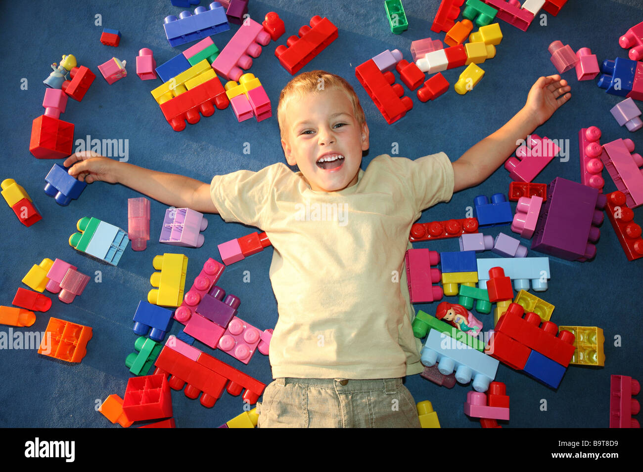 Toddler boy laying on floor playing hi-res stock photography and images ...