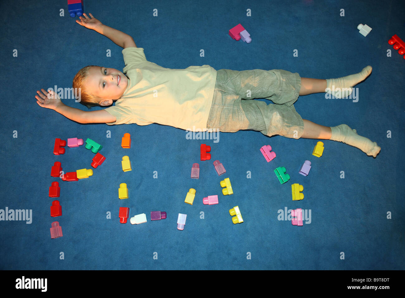 boy laying on floor Stock Photo - Alamy