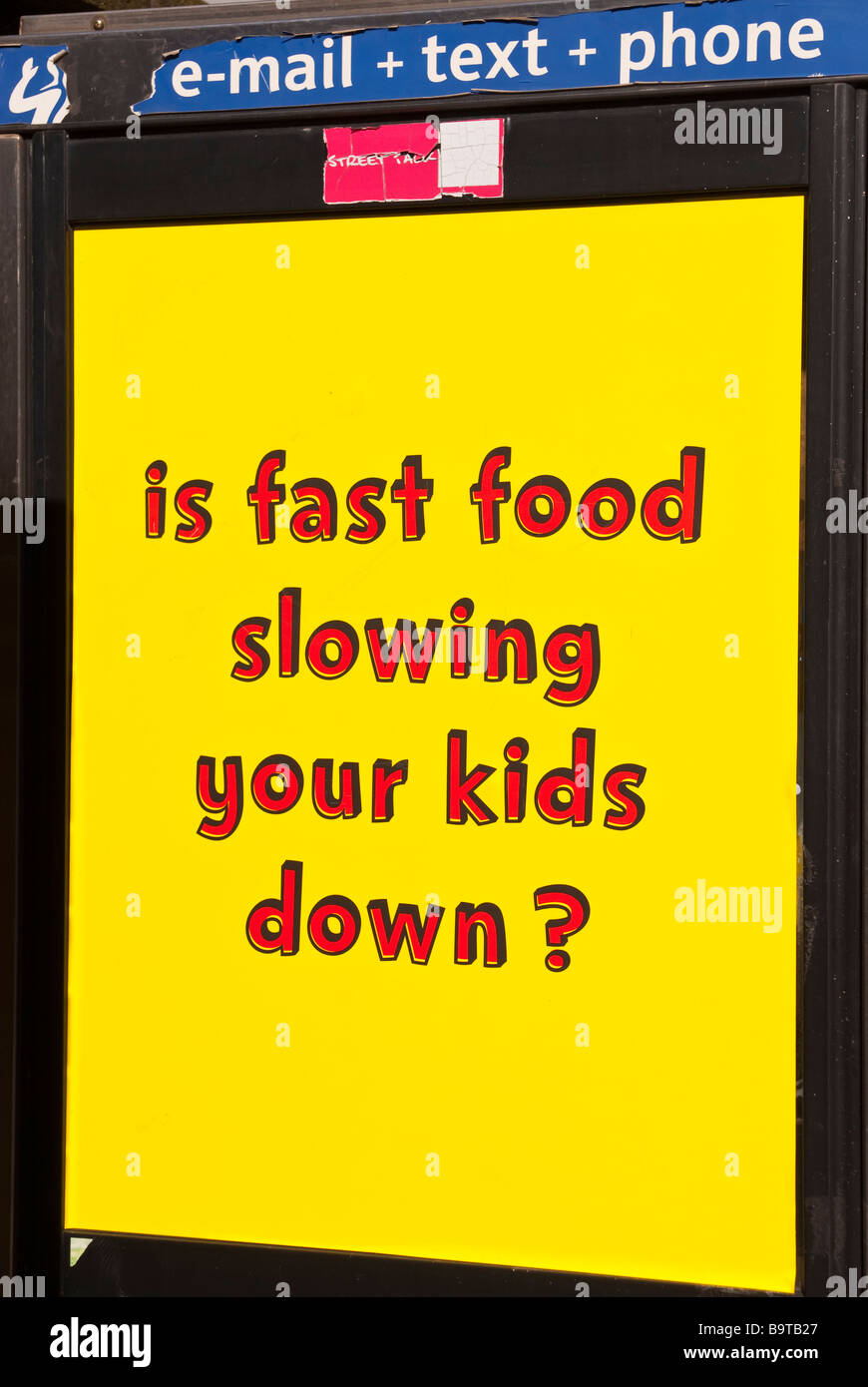 A sign on a phonebox warning of kids eating junk food Stock Photo - Alamy