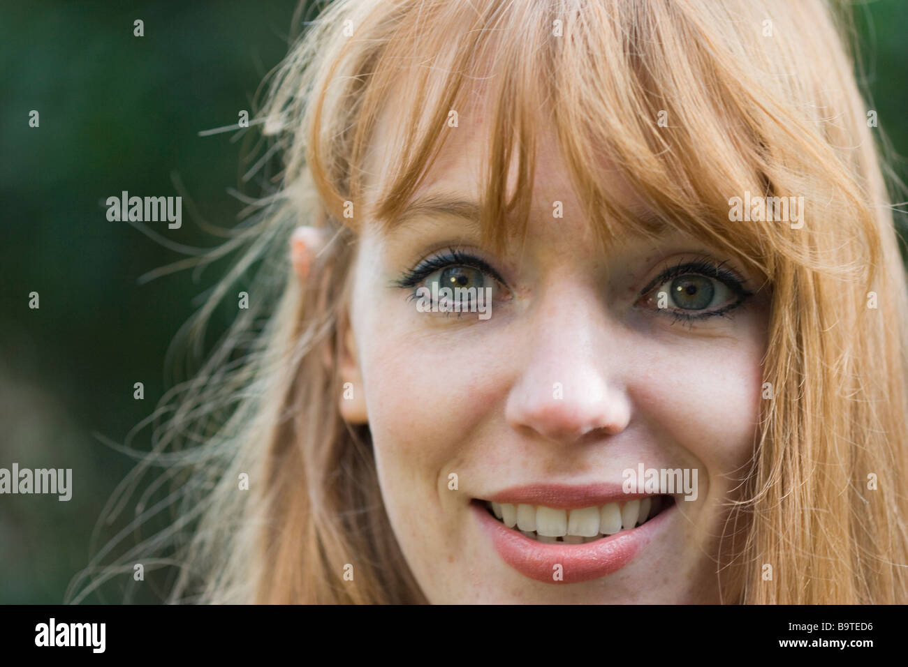 Red haired woman smiling Stock Photo - Alamy
