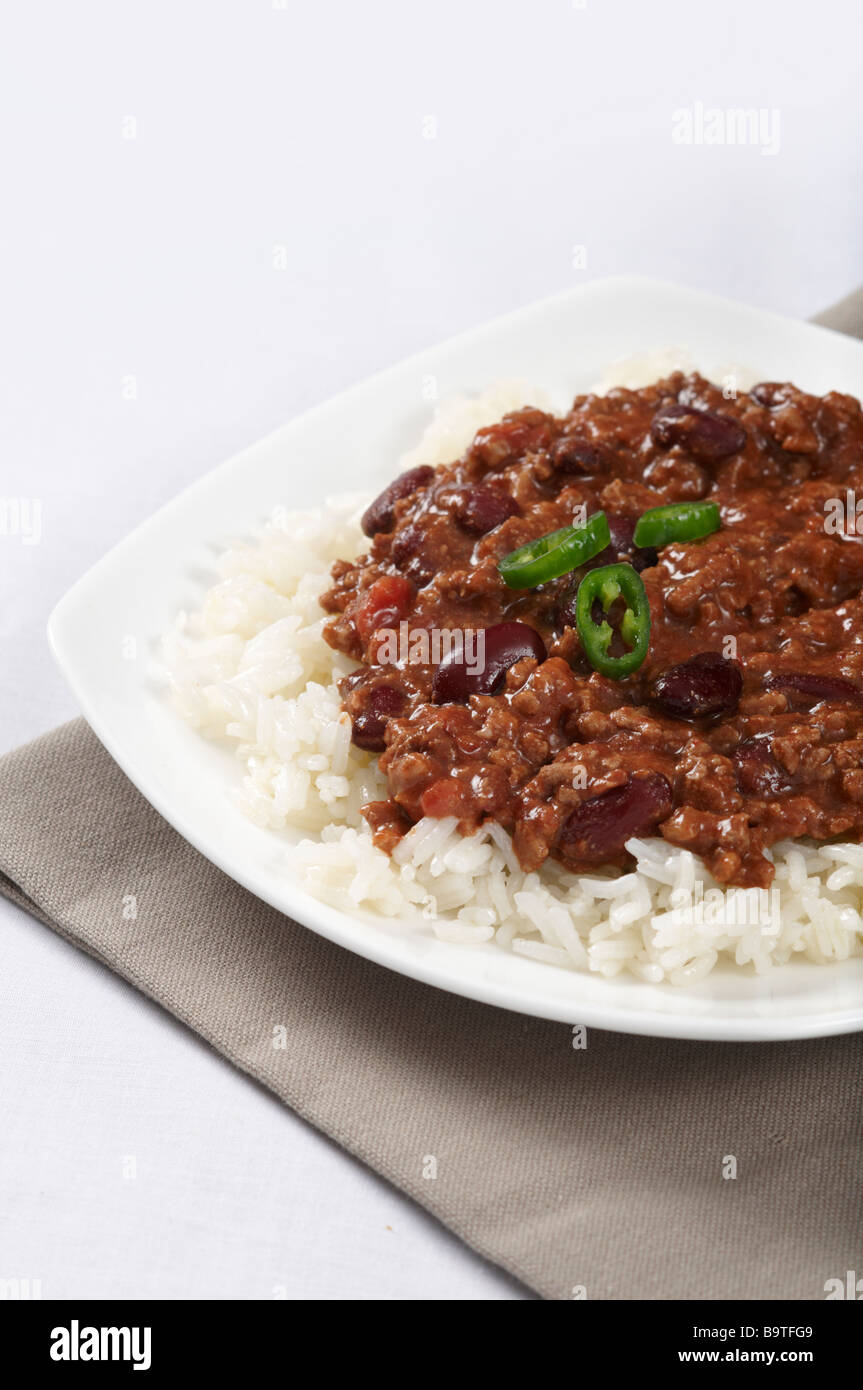 A plate of chilli con carne with rice and green chilli garnish Stock ...