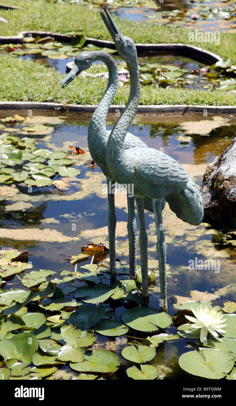 Statues of Herons at a pond featuring a grassy relief map of Bermuda ...