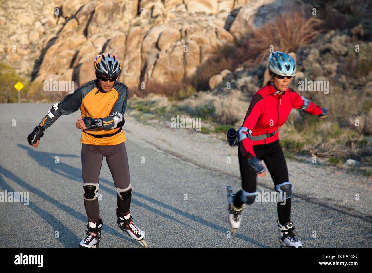 Couple roller blading Stock Photo - Alamy