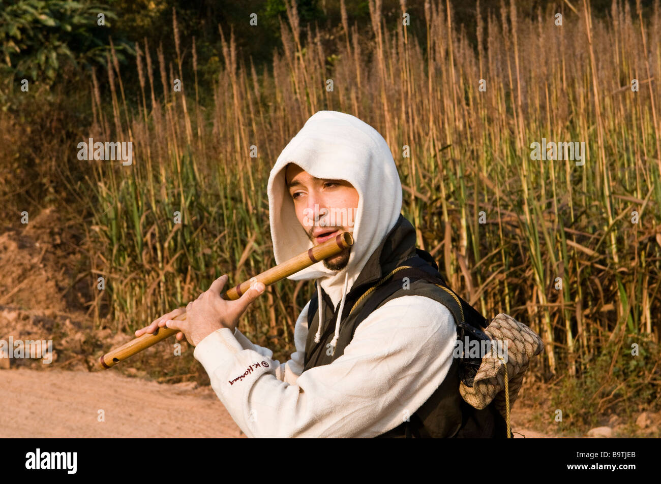 A musician plays his flute out in the nature Stock Photo - Alamy