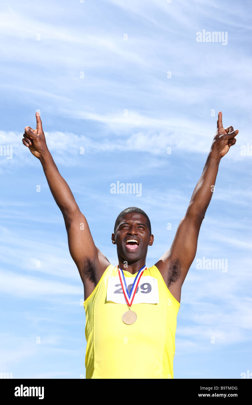 Athlete celebrating with gold medal Stock Photo - Alamy