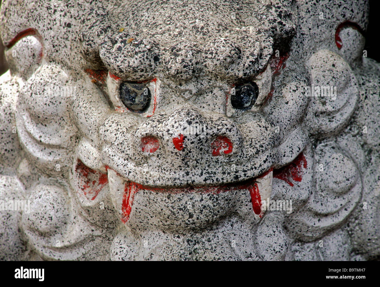 Closeup view of stone guardian dragon near entrance to local shrine in ...