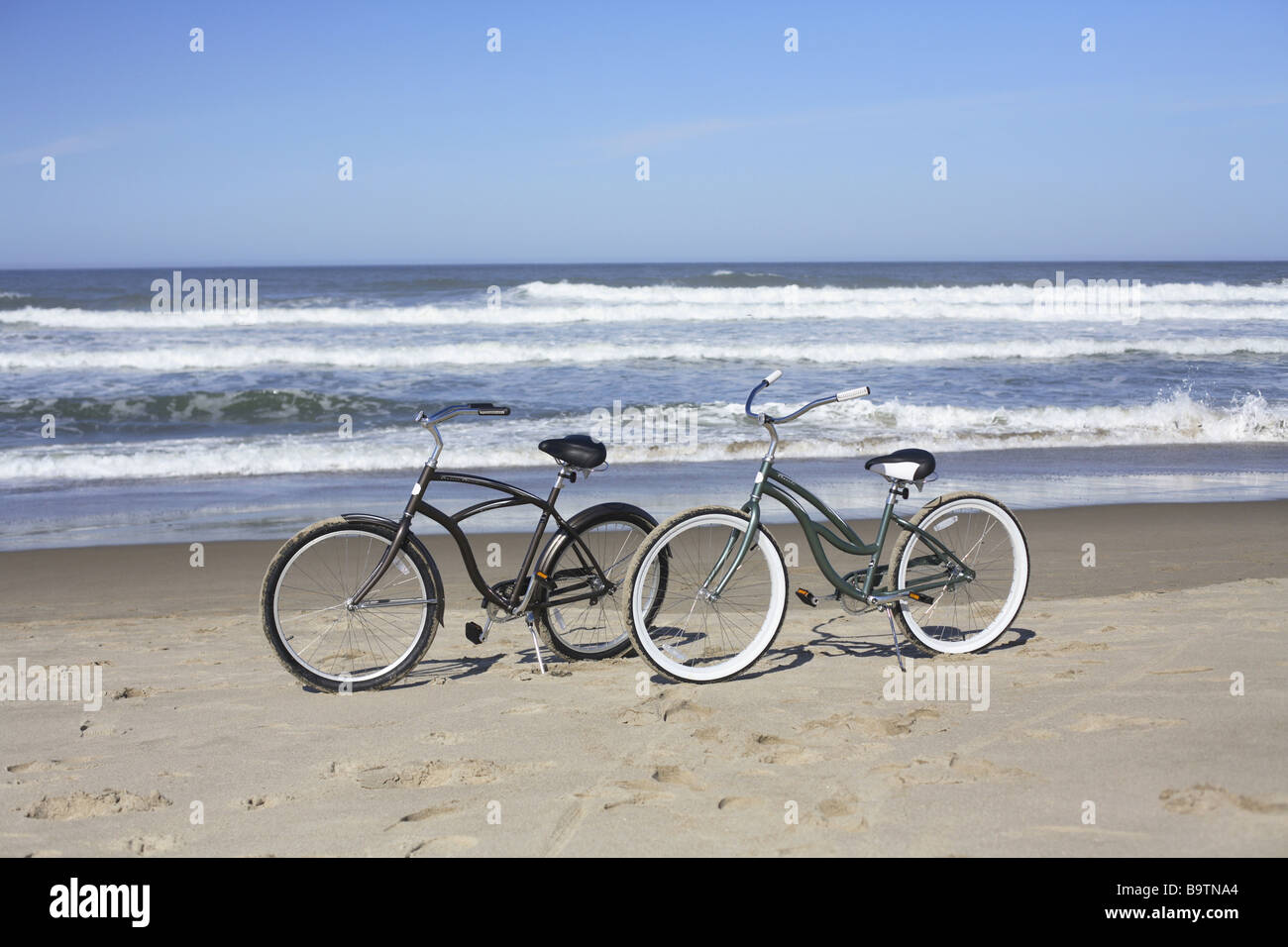 Two bicycle on beach Stock Photo - Alamy