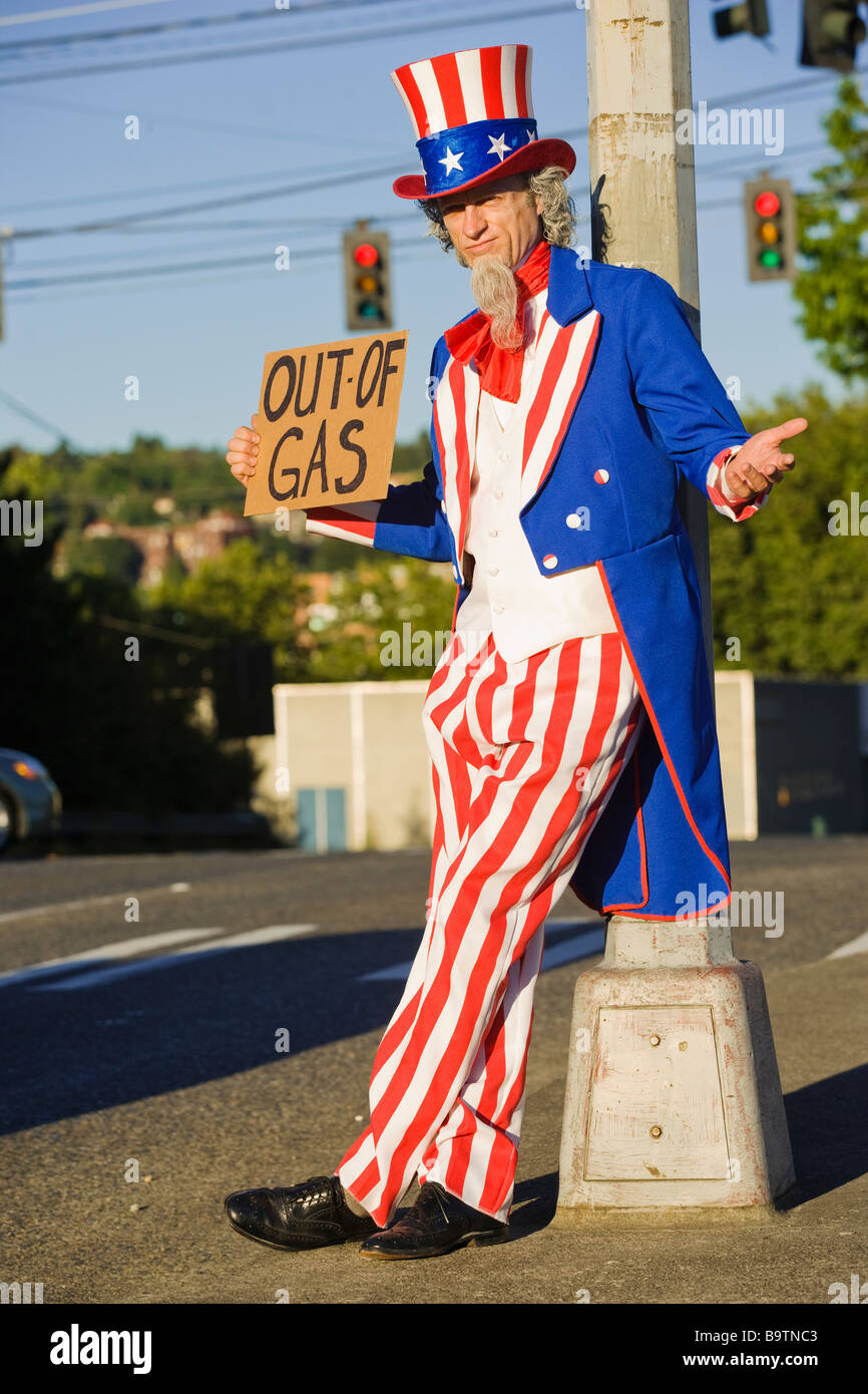 Uncle Sam on the side of the road holding a Out of Gas sign Stock Photo ...