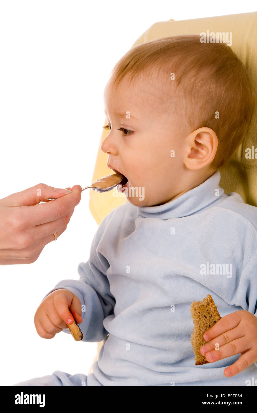 feeding of small boy on white background Stock Photo - Alamy