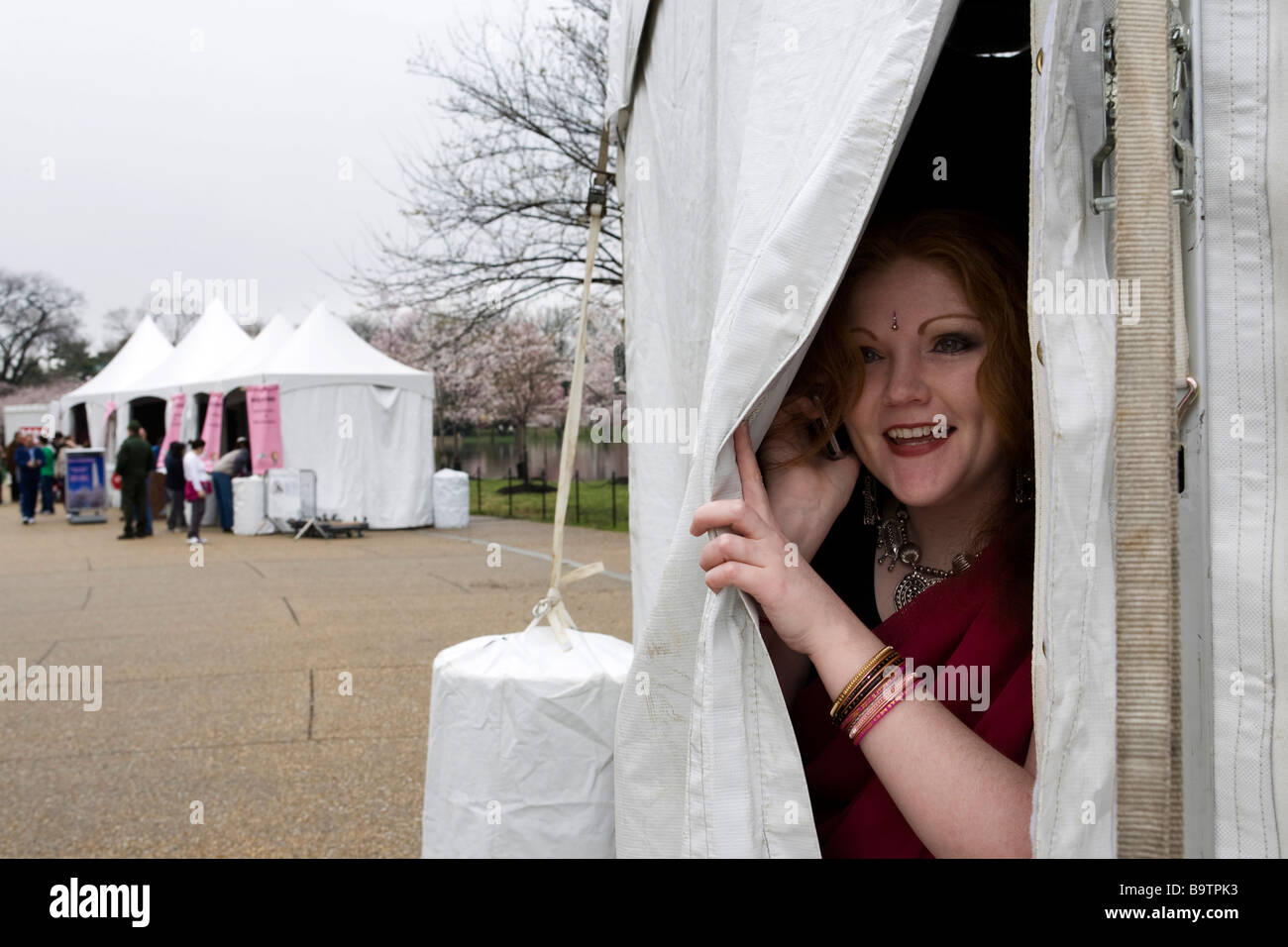 Female on mobile phone peeks out from tent Stock Photo - Alamy